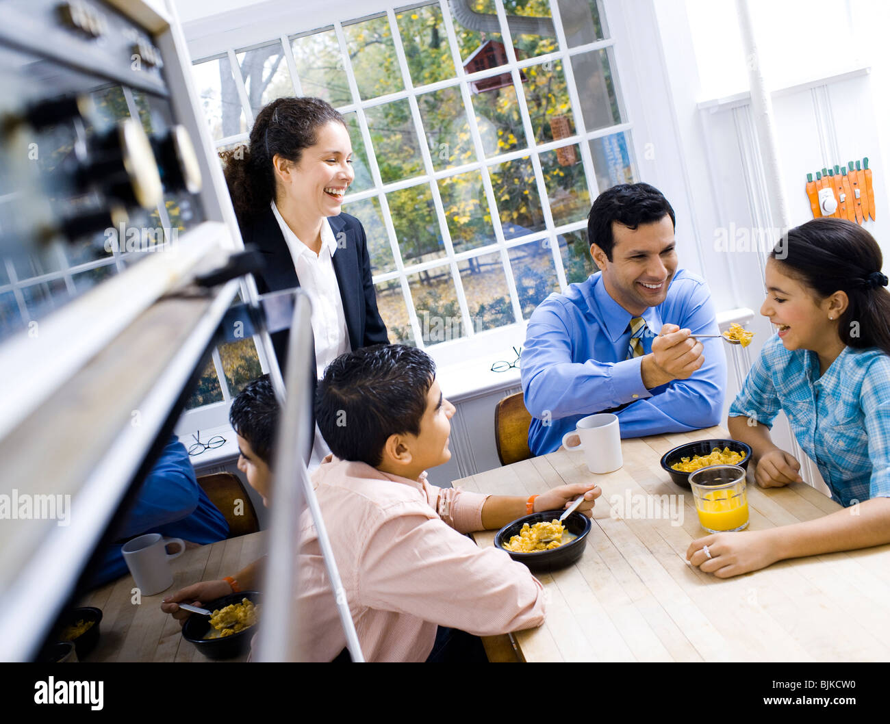 Family at breakfast table smiling Stock Photo - Alamy
