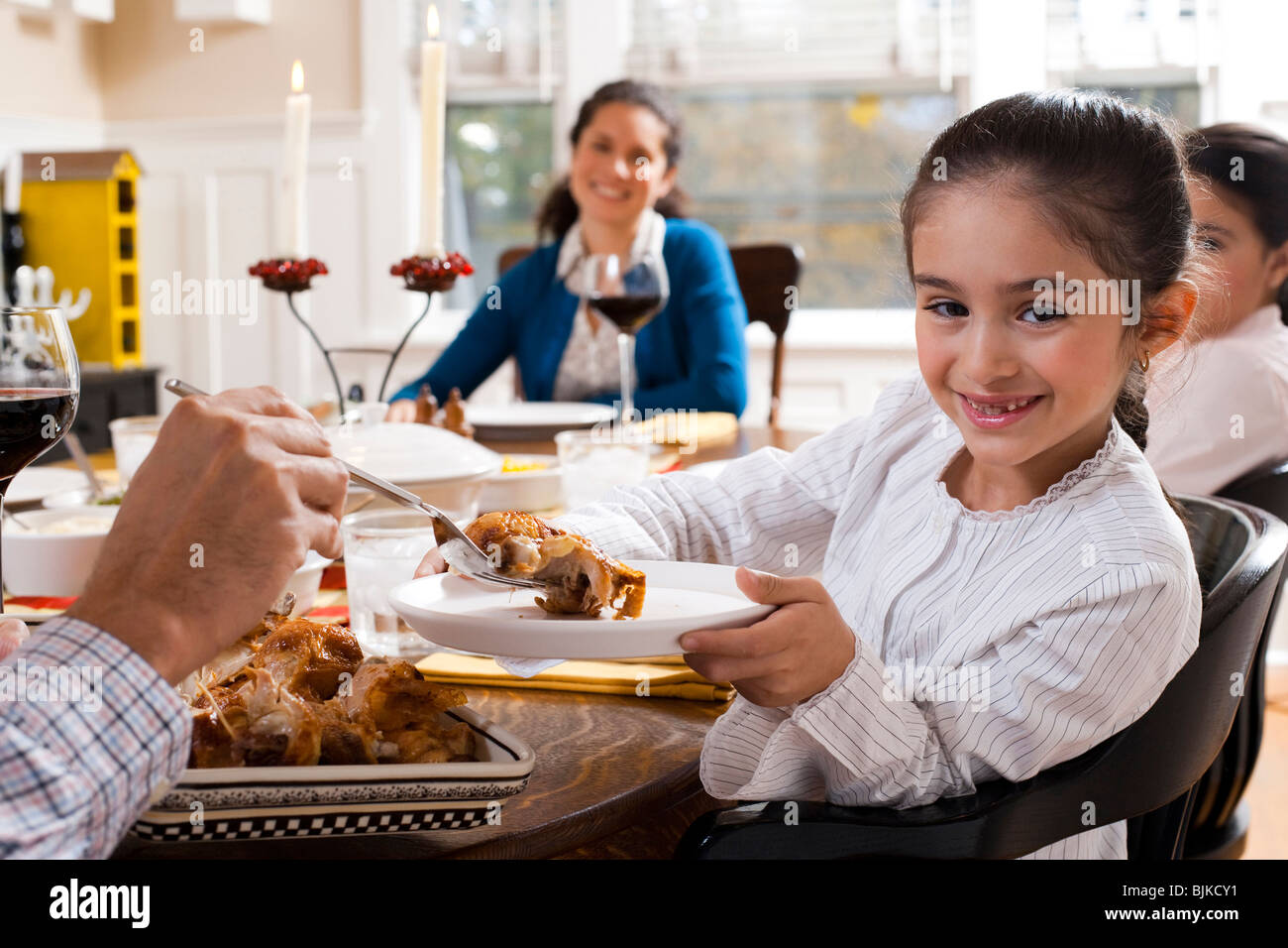 Family sitting at dinner table Stock Photo - Alamy