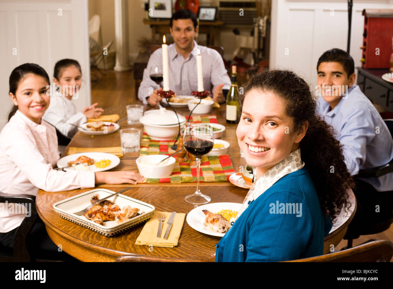 Family at dinner table smiling Stock Photo - Alamy