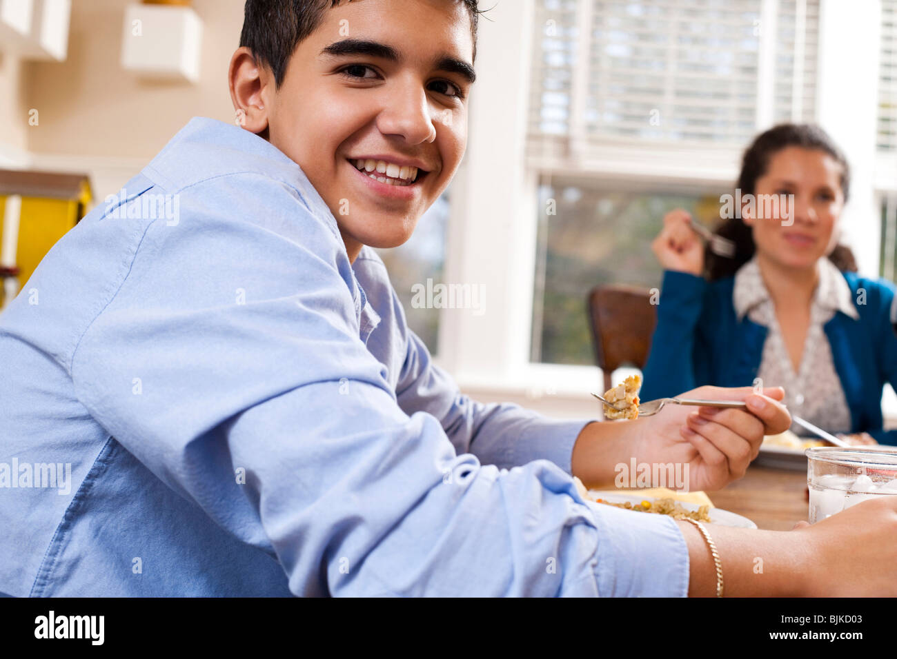 Boy eating green beans smiling Stock Photo - Alamy