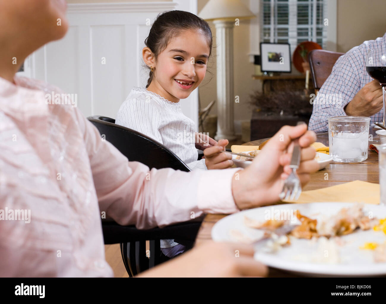 Girls at dinner table eating Stock Photo - Alamy