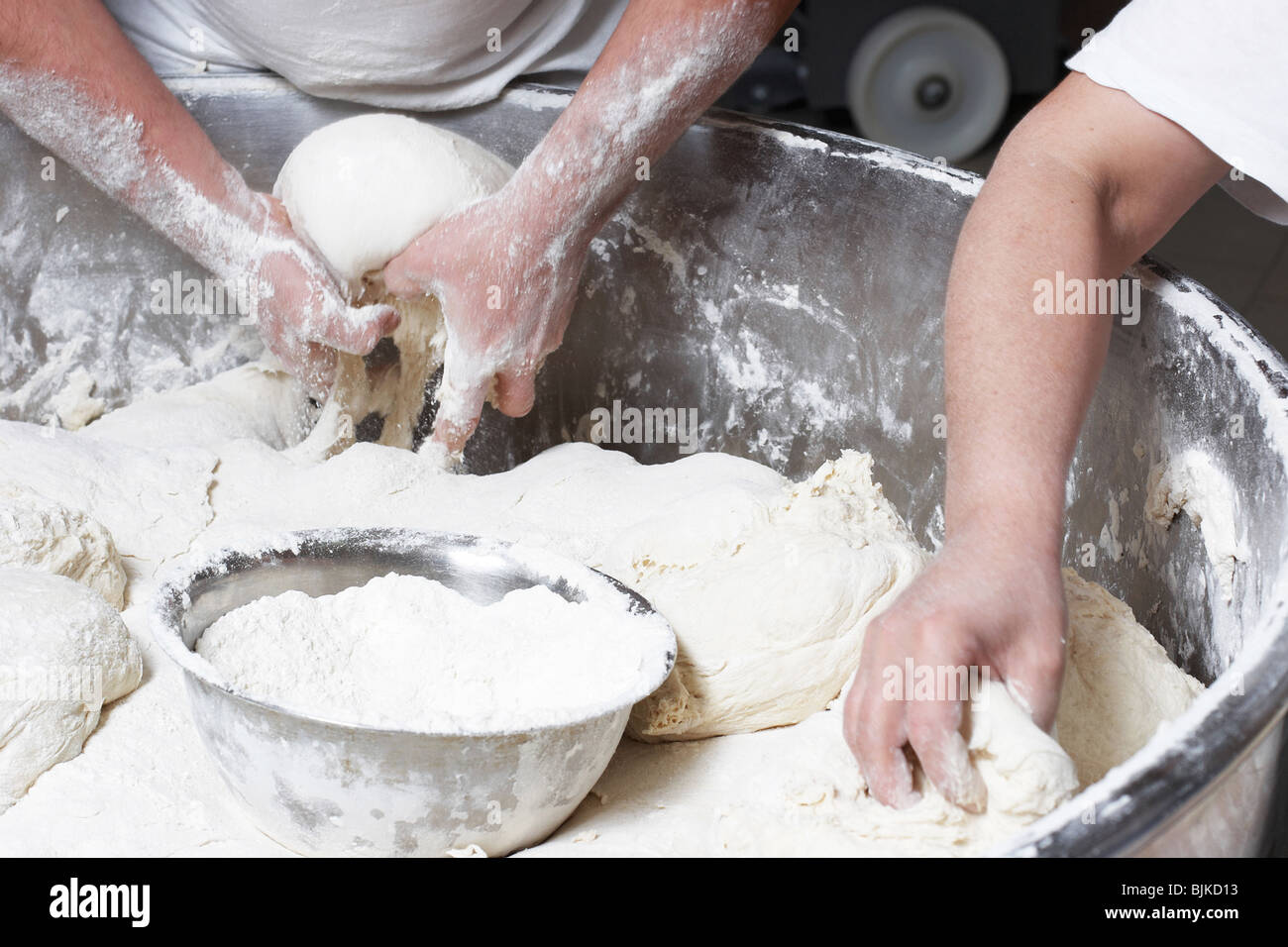Bakery team at work taking dough for mixing Stock Photo - Alamy