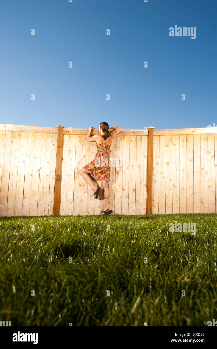 Woman climbing over fence hi-res stock photography and images - Alamy