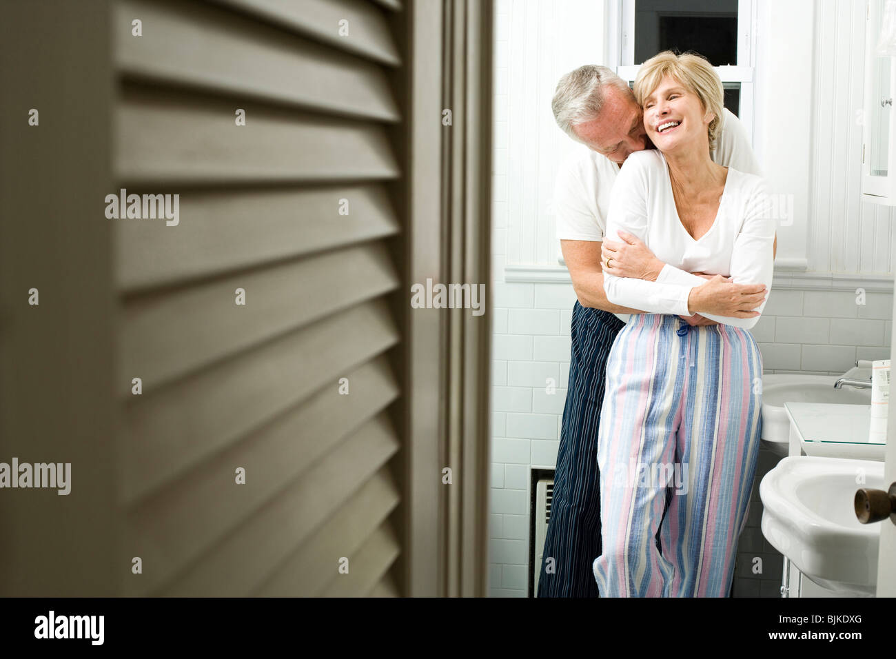 Mature couple in bathroom embracing Stock Photo - Alamy