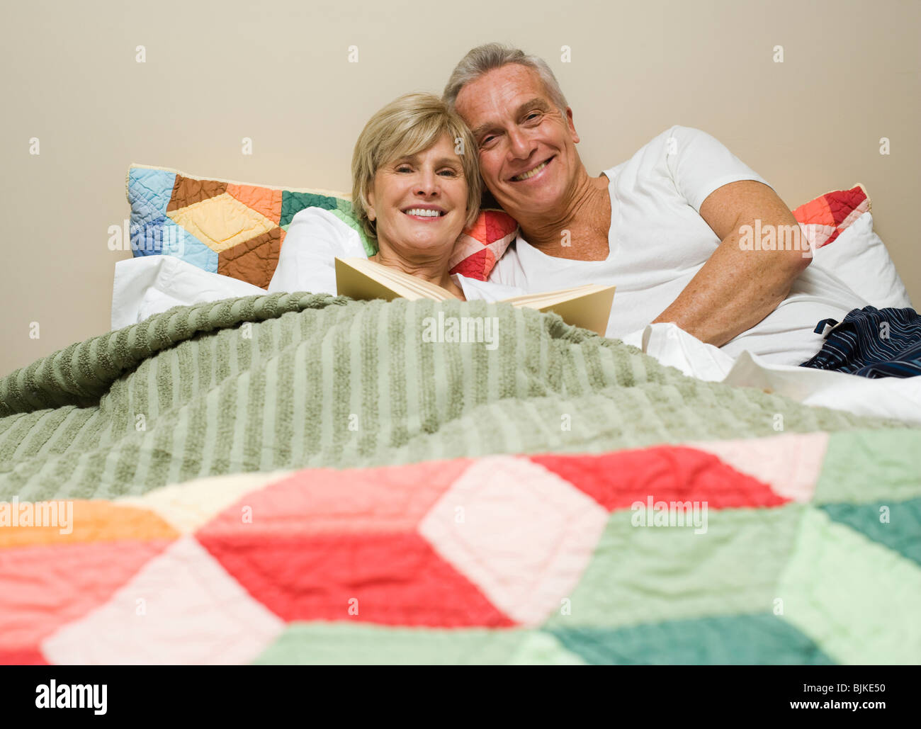 Mature couple cuddle bed hi-res stock photography and images - Alamy