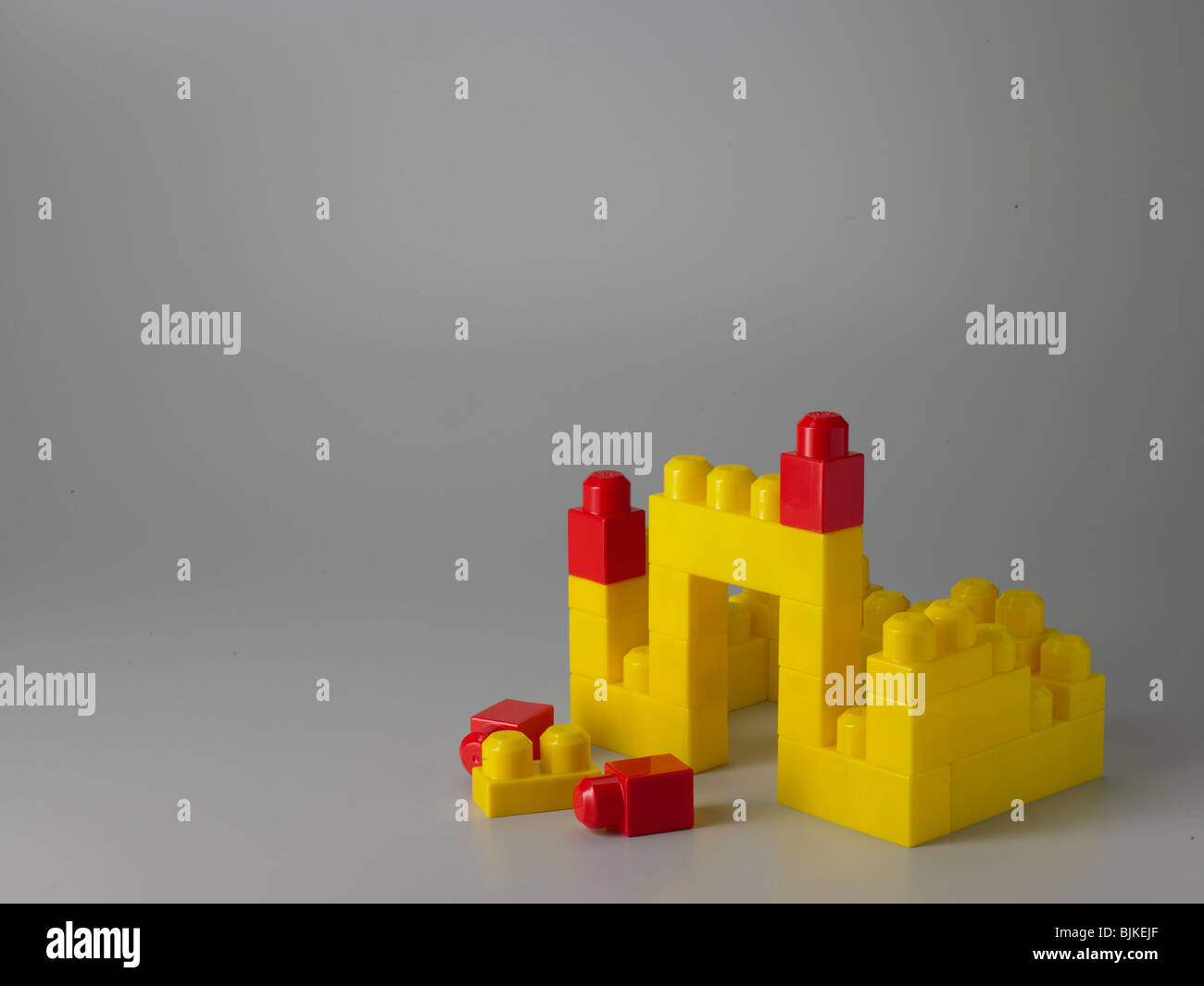 Toy blocks showing building and structure falling down Stock Photo - Alamy