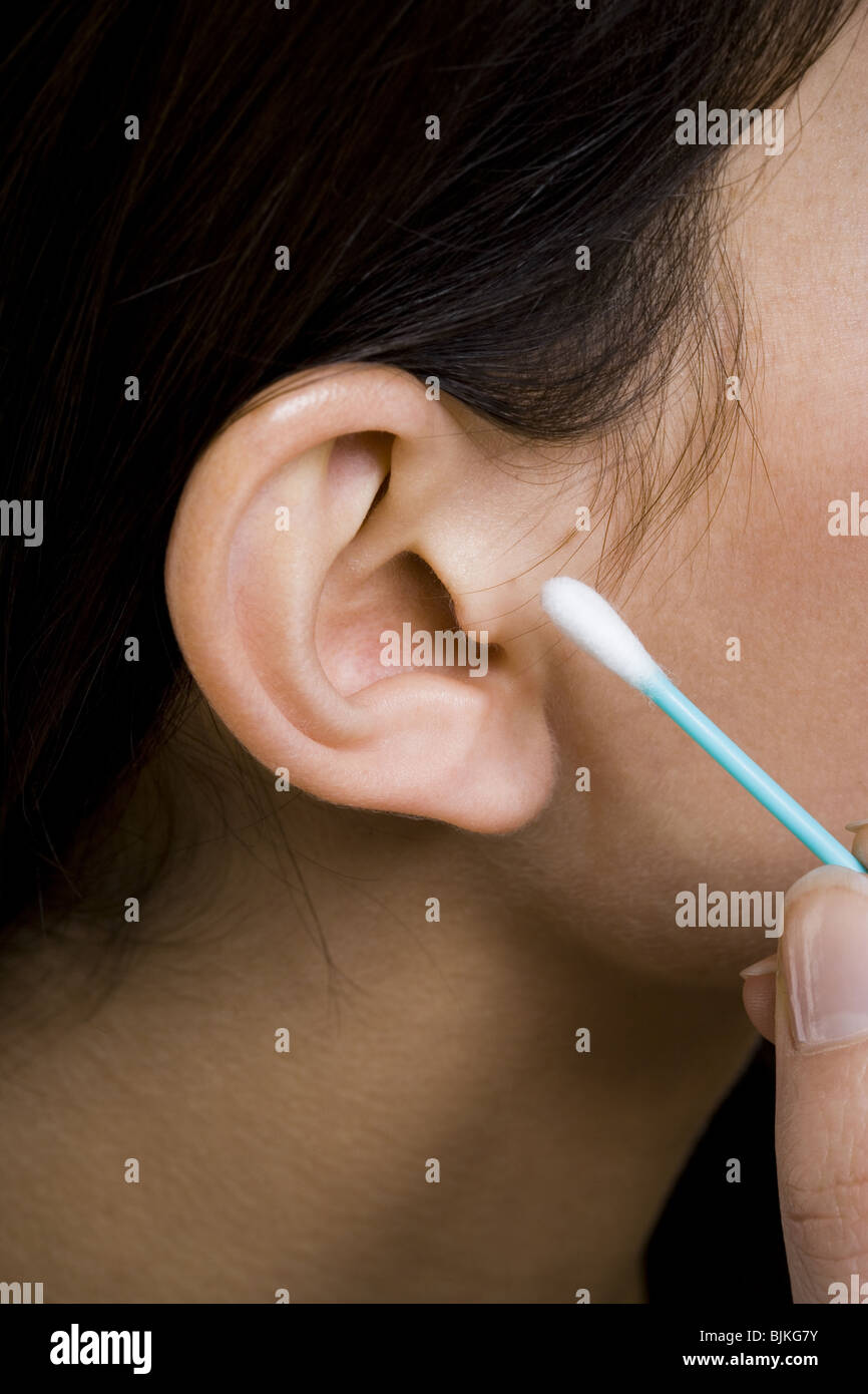 Closeup of female ear with cotton swab Stock Photo - Alamy