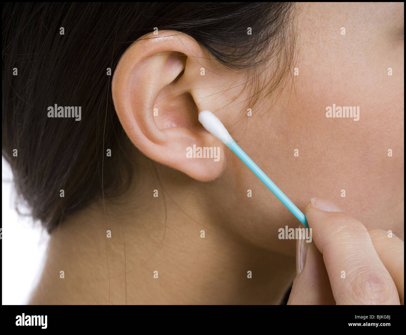 Closeup of female ear with cotton swab Stock Photo - Alamy