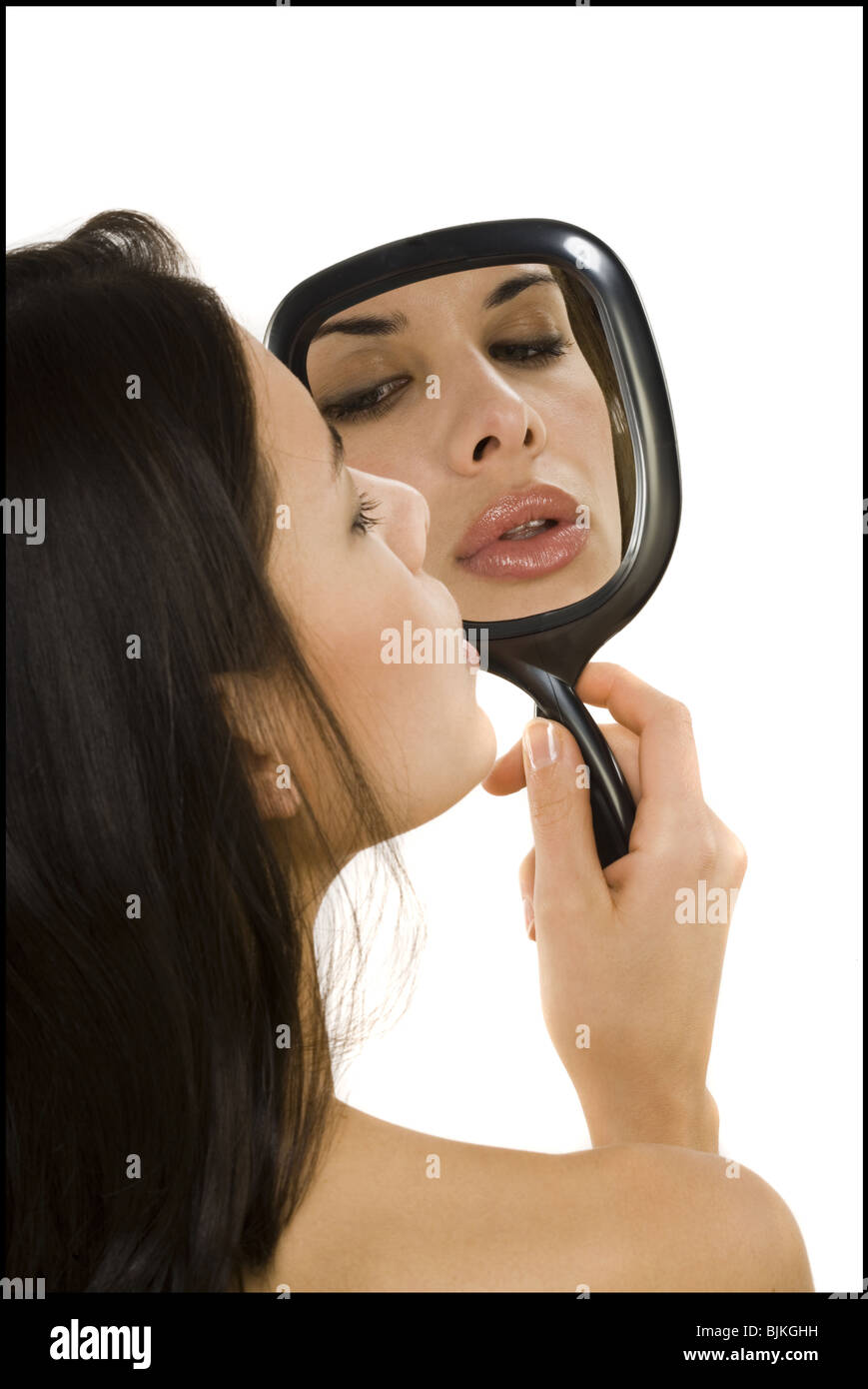Reflection of woman in hand mirror Stock Photo - Alamy