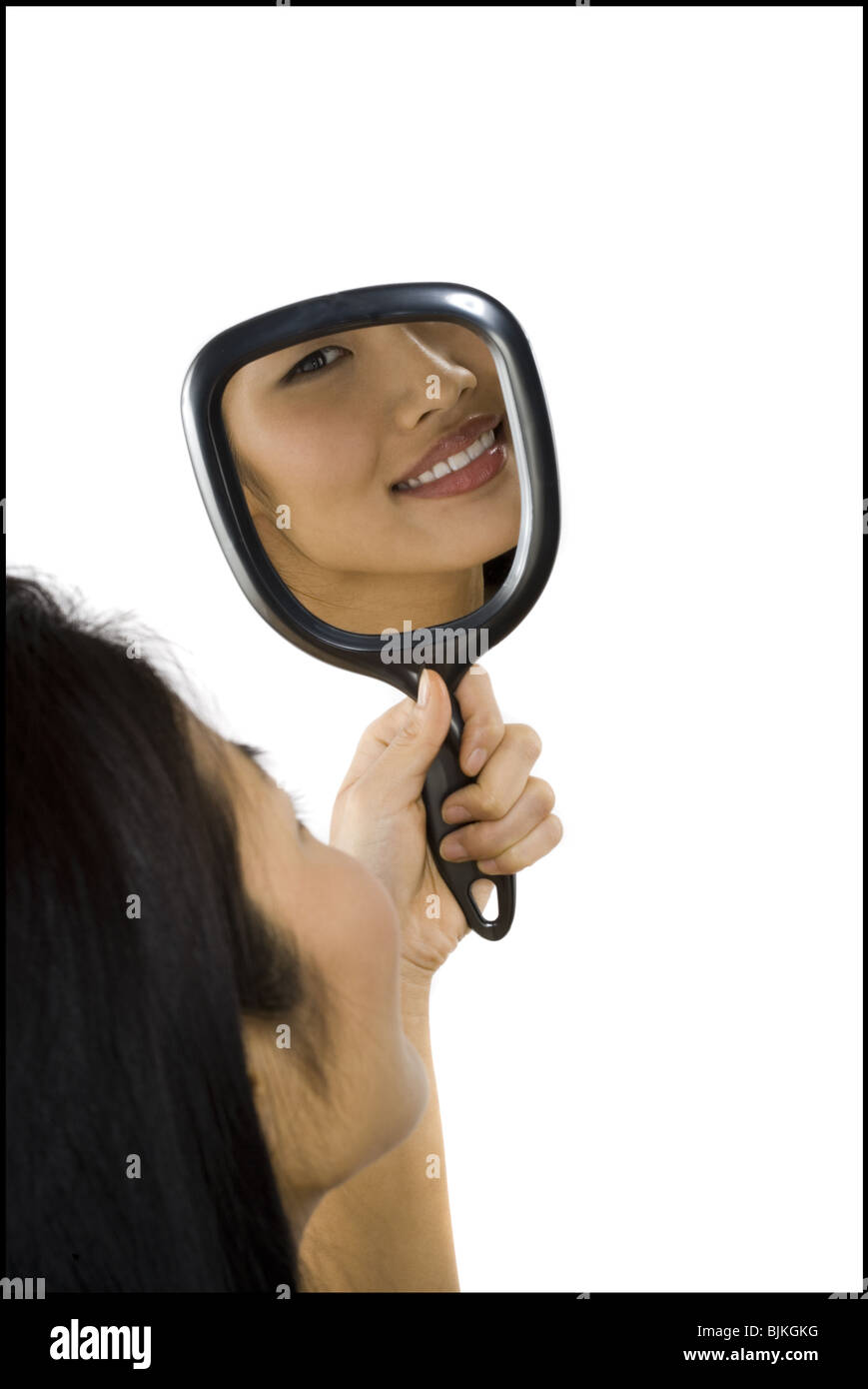 Reflection of woman in hand mirror Stock Photo - Alamy