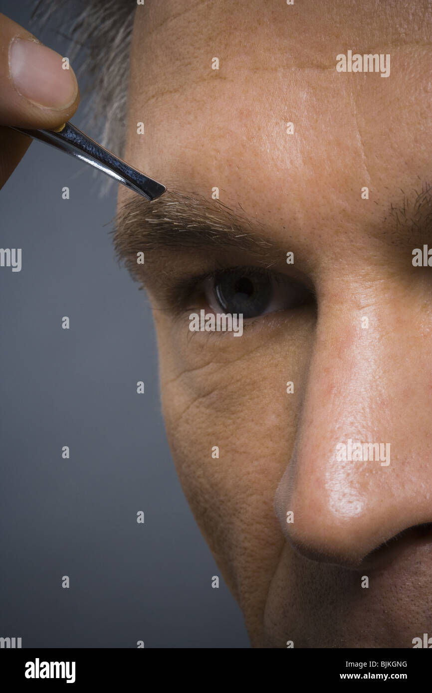 Man and plucking eyebrows hi-res stock photography and images - Alamy