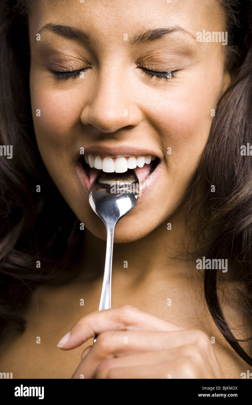 Woman eating with a spoon Stock Photo - Alamy