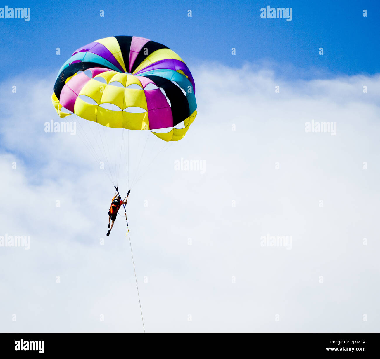 Man with parachute floating Stock Photo - Alamy