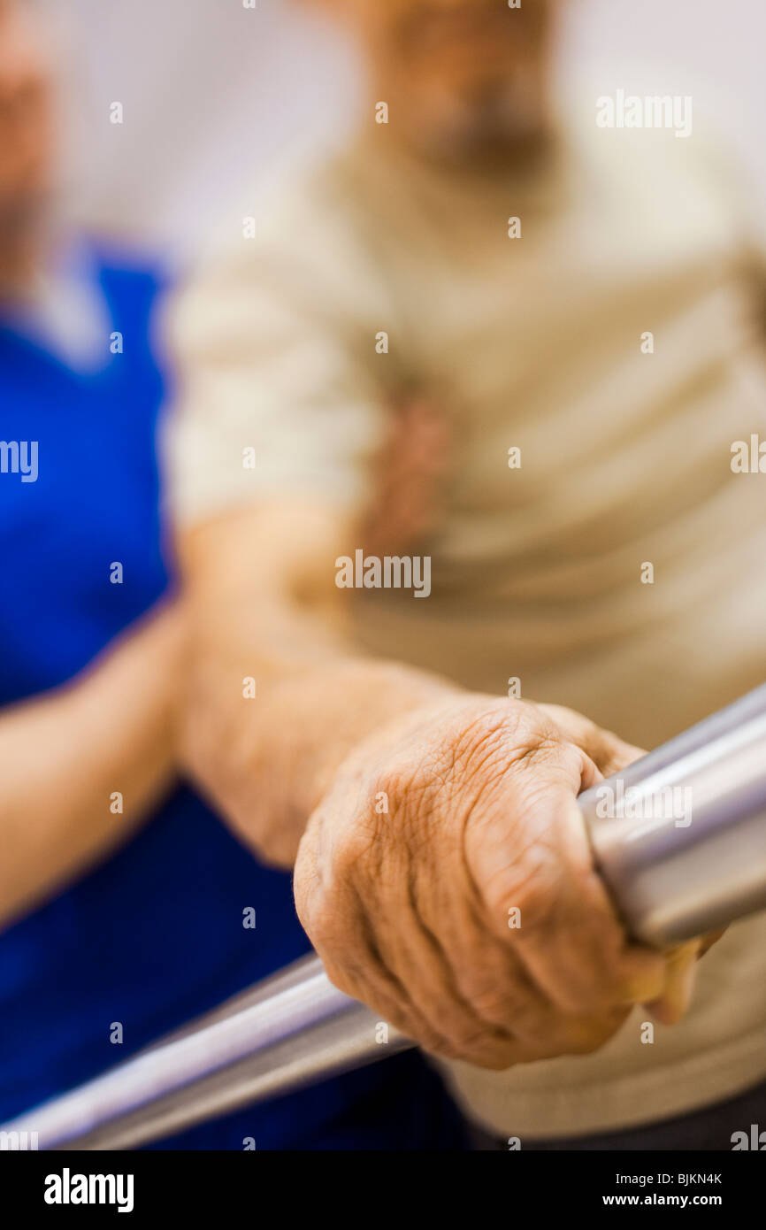 Physical therapist holding patient walking hi-res stock photography and ...