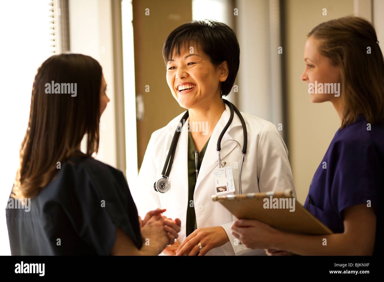 Female hospital staff talking Stock Photo - Alamy