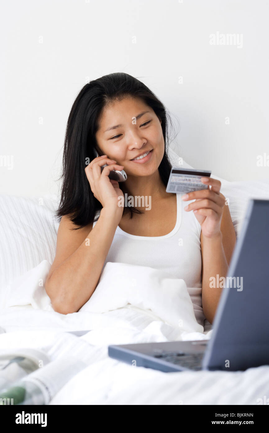 Woman working from bed Stock Photo - Alamy
