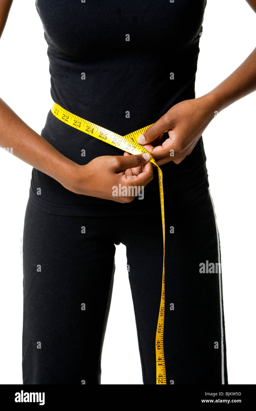 Woman measuring waist with tape measure Stock Photo - Alamy