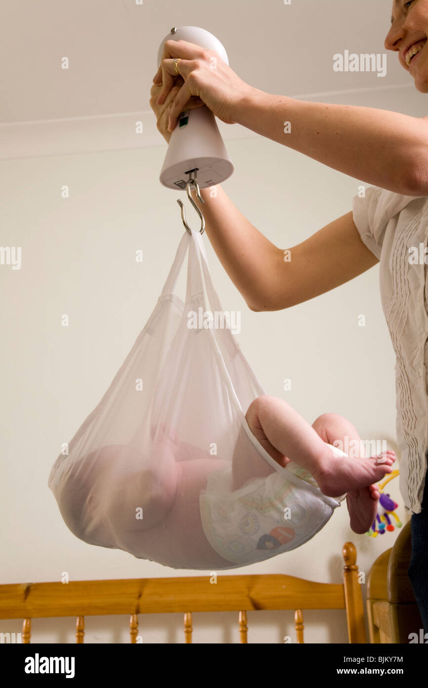 Weighing a newborn / new born baby with scales / weight scale Stock ... Weighing a newborn / new born baby with scales / weight scale Stock ...
