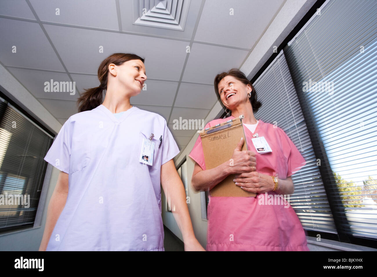 Nurses walking and talking Stock Photo - Alamy