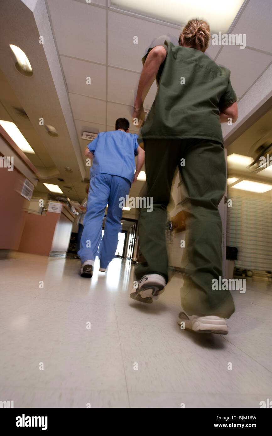 Doctor and nurse running in corridor from behind Stock Photo - Alamy