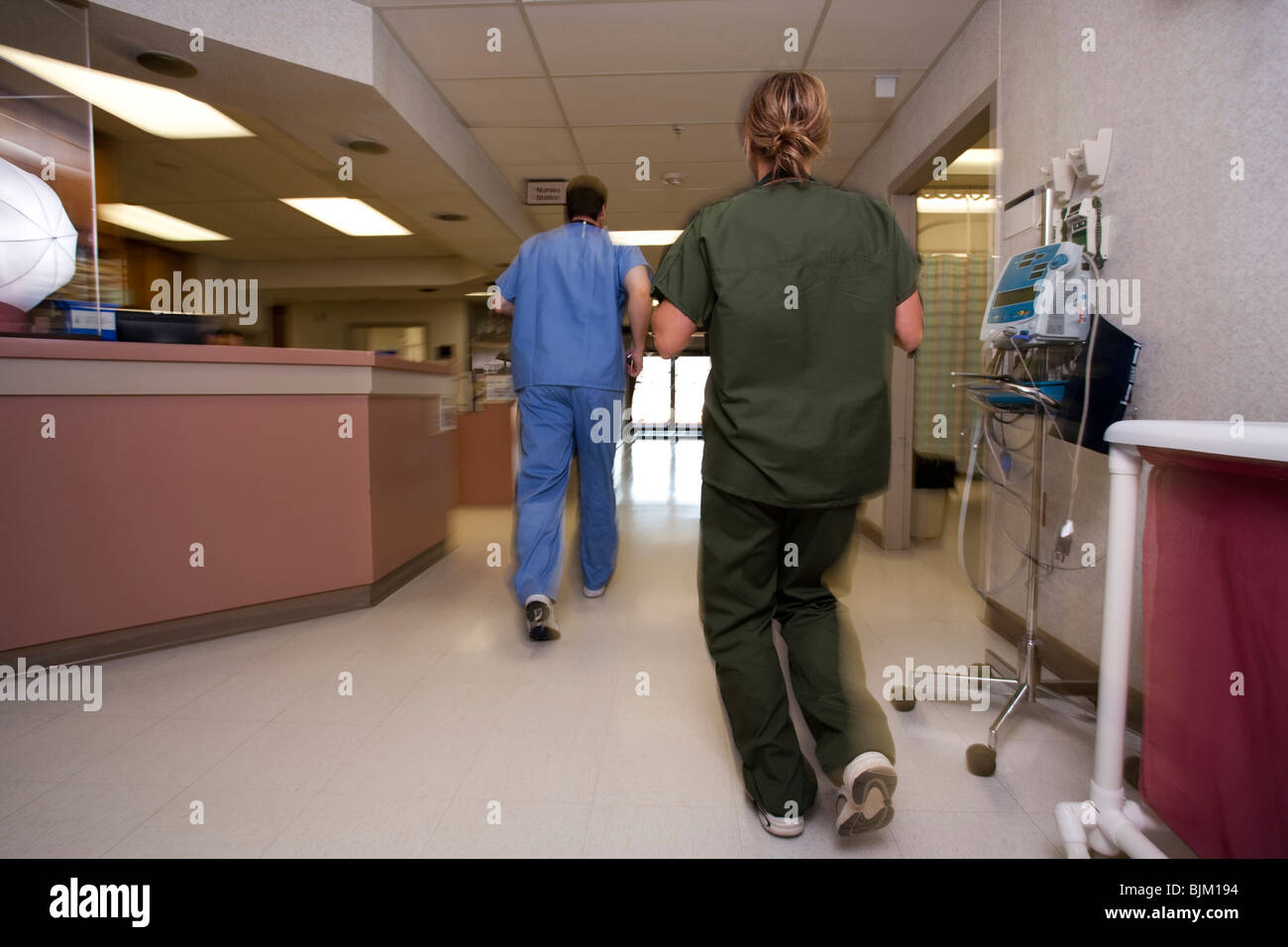 Doctor and nurse running in corridor from behind Stock Photo - Alamy