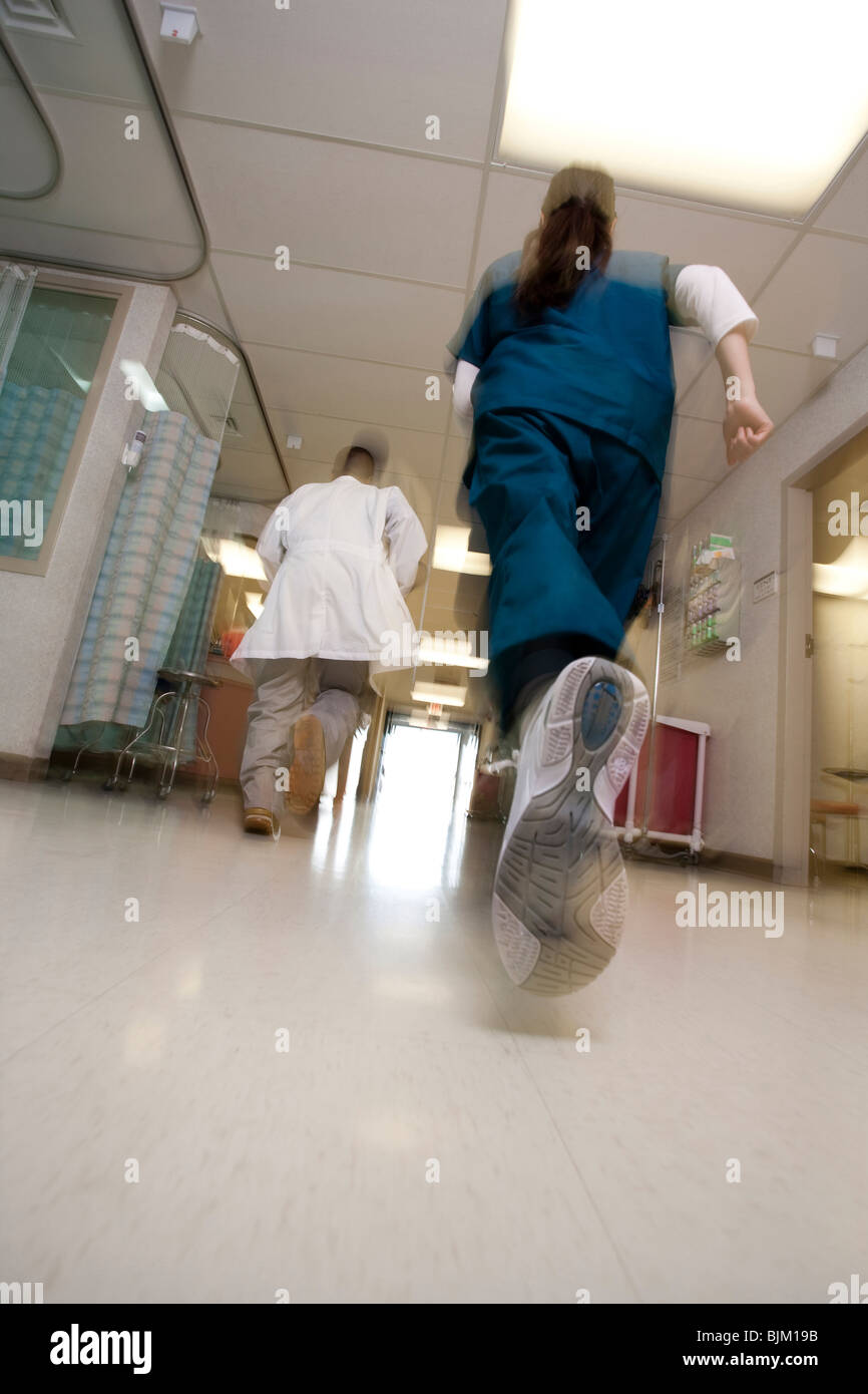 Doctor and nurse rushing through corridor Stock Photo - Alamy
