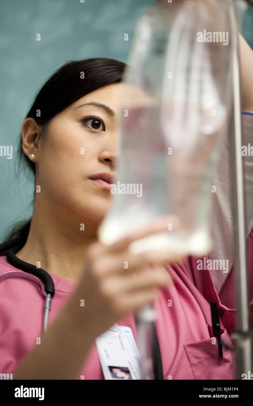 Closeup of nurse adjusting IV bag Stock Photo - Alamy