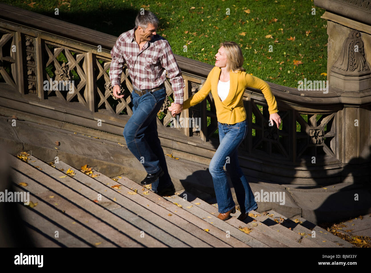 Couple walking up stairs Stock Photo - Alamy