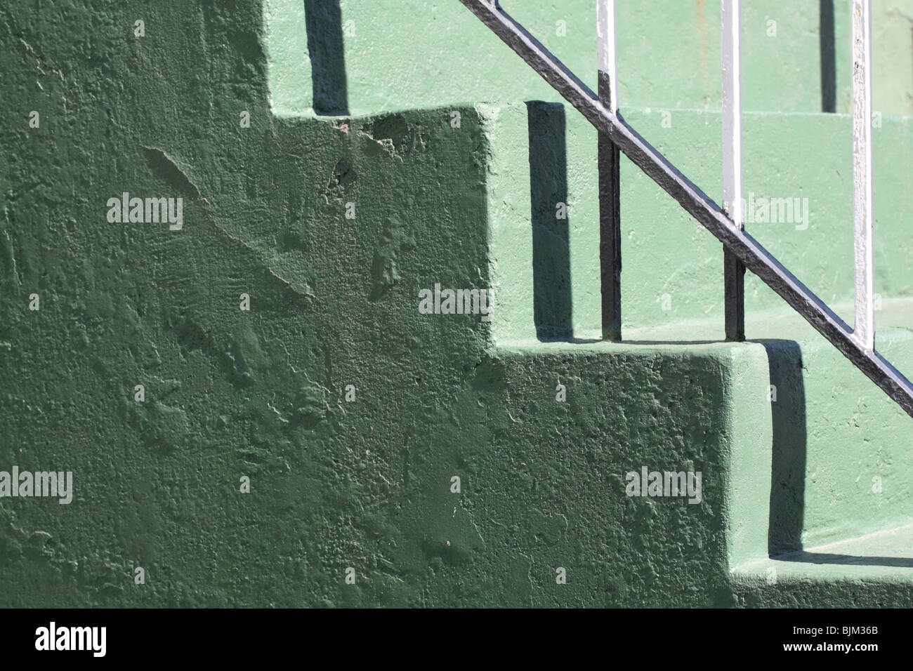 Green steps and high noon shadow Stock Photo - Alamy