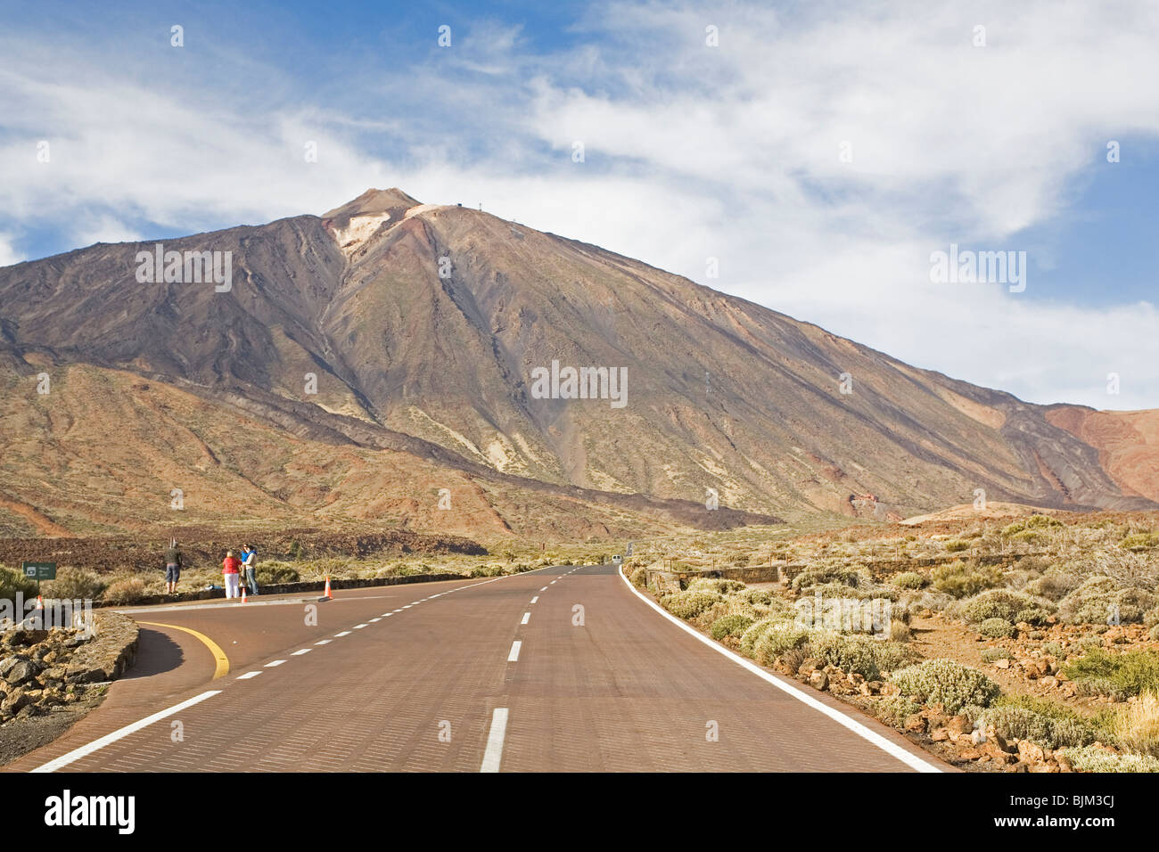 A road runs under the 3718 metre high Mount Teide in the Teide National ...