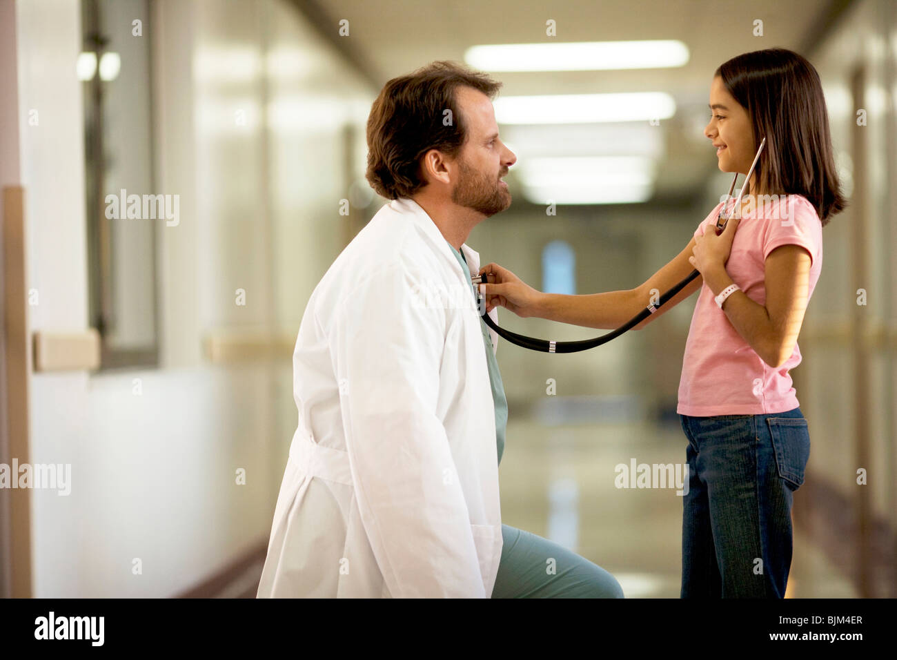 Young girl playing with female doctor's stethoscope Stock Photo - Alamy