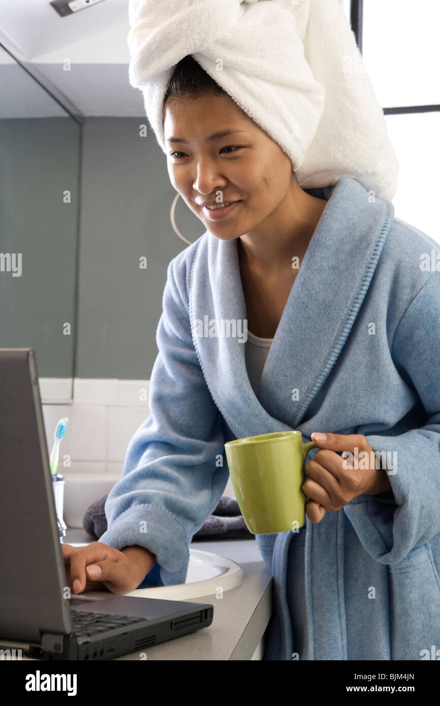 Female in bathroom with laptop Stock Photo - Alamy