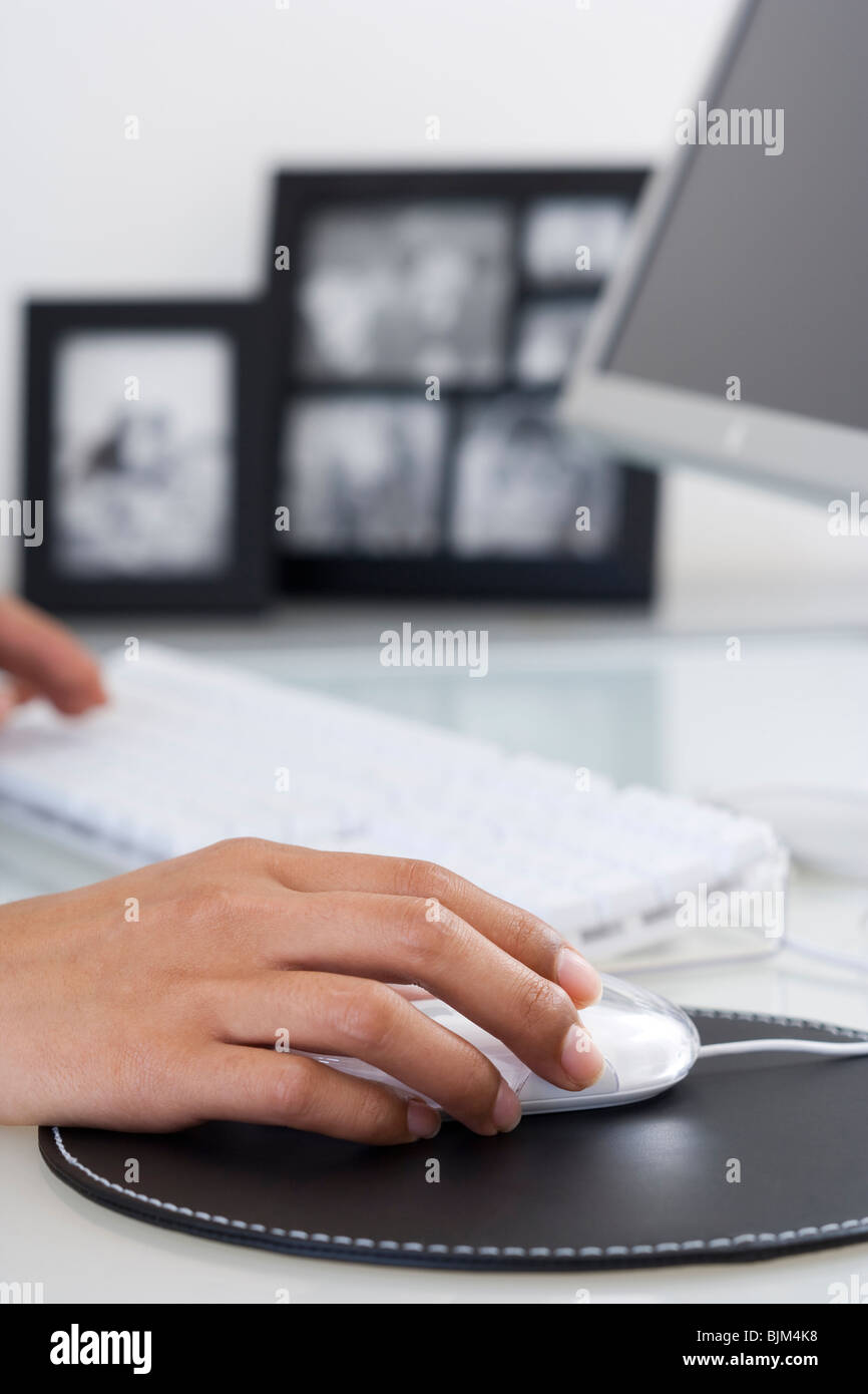 Female hand on mouse with keyboard Stock Photo - Alamy