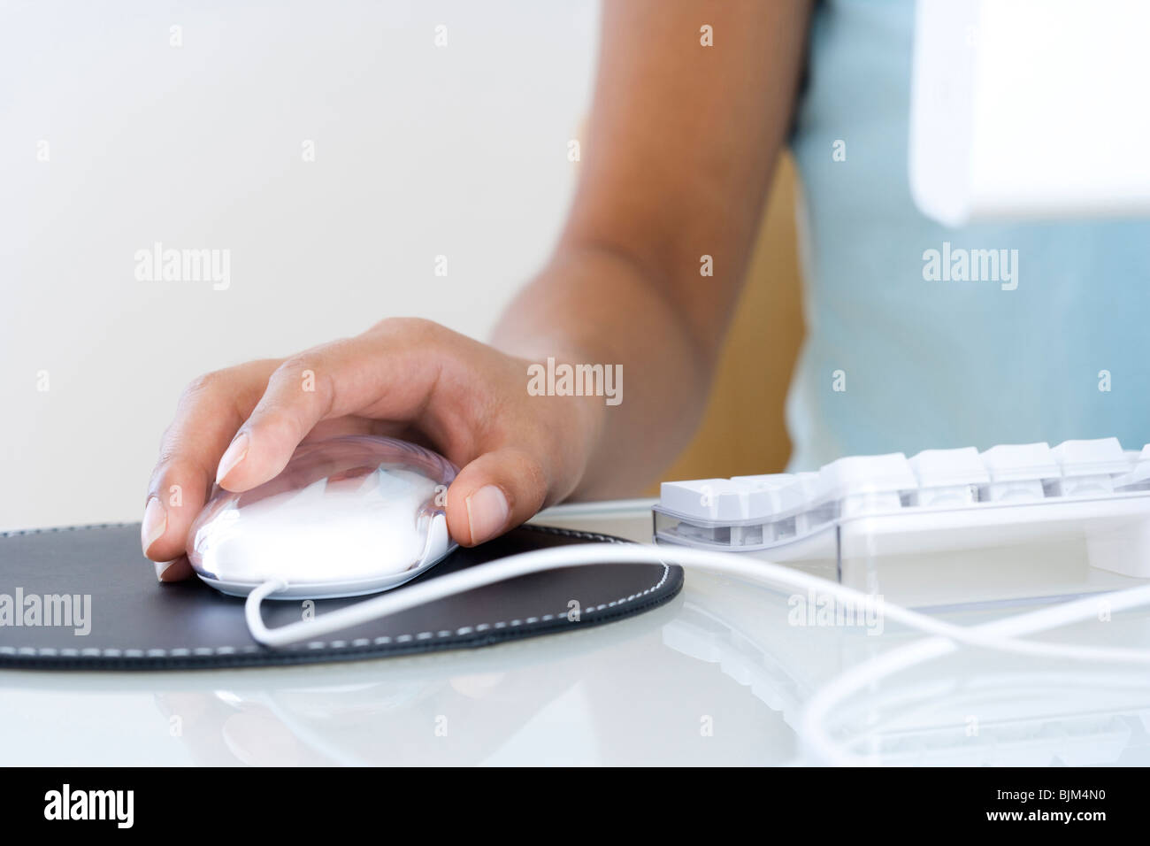 Female hand on mouse with keyboard Stock Photo - Alamy