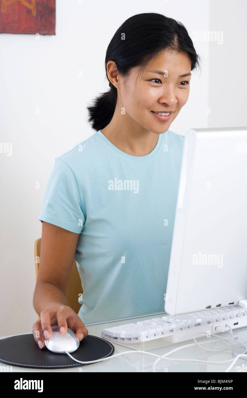 Female hand on mouse with keyboard Stock Photo - Alamy