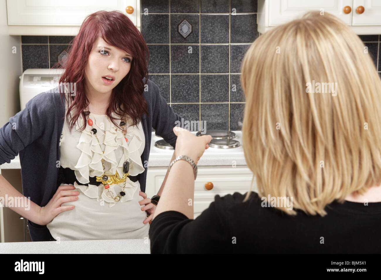 Mother and her teenage daughter arguing in a kitchen Stock Photo - Alamy