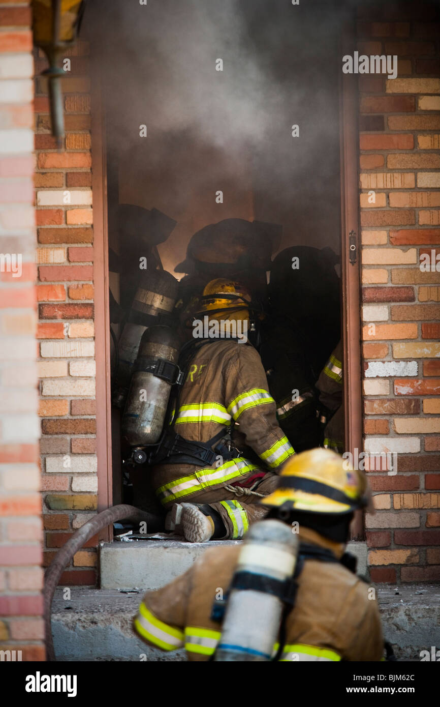 Rear View of fire fighters Stock Photo - Alamy