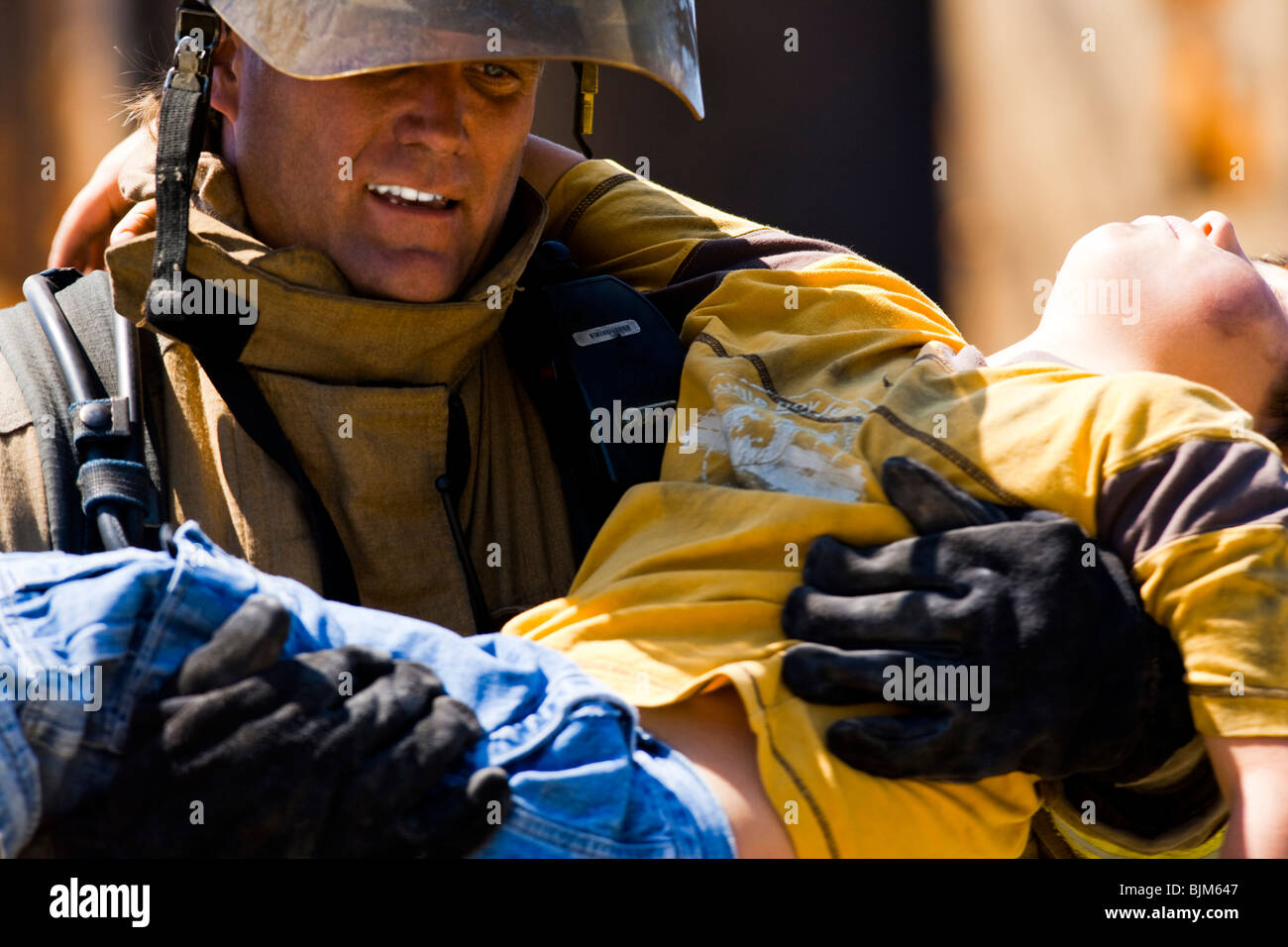Fire fighter rescuing child Stock Photo - Alamy