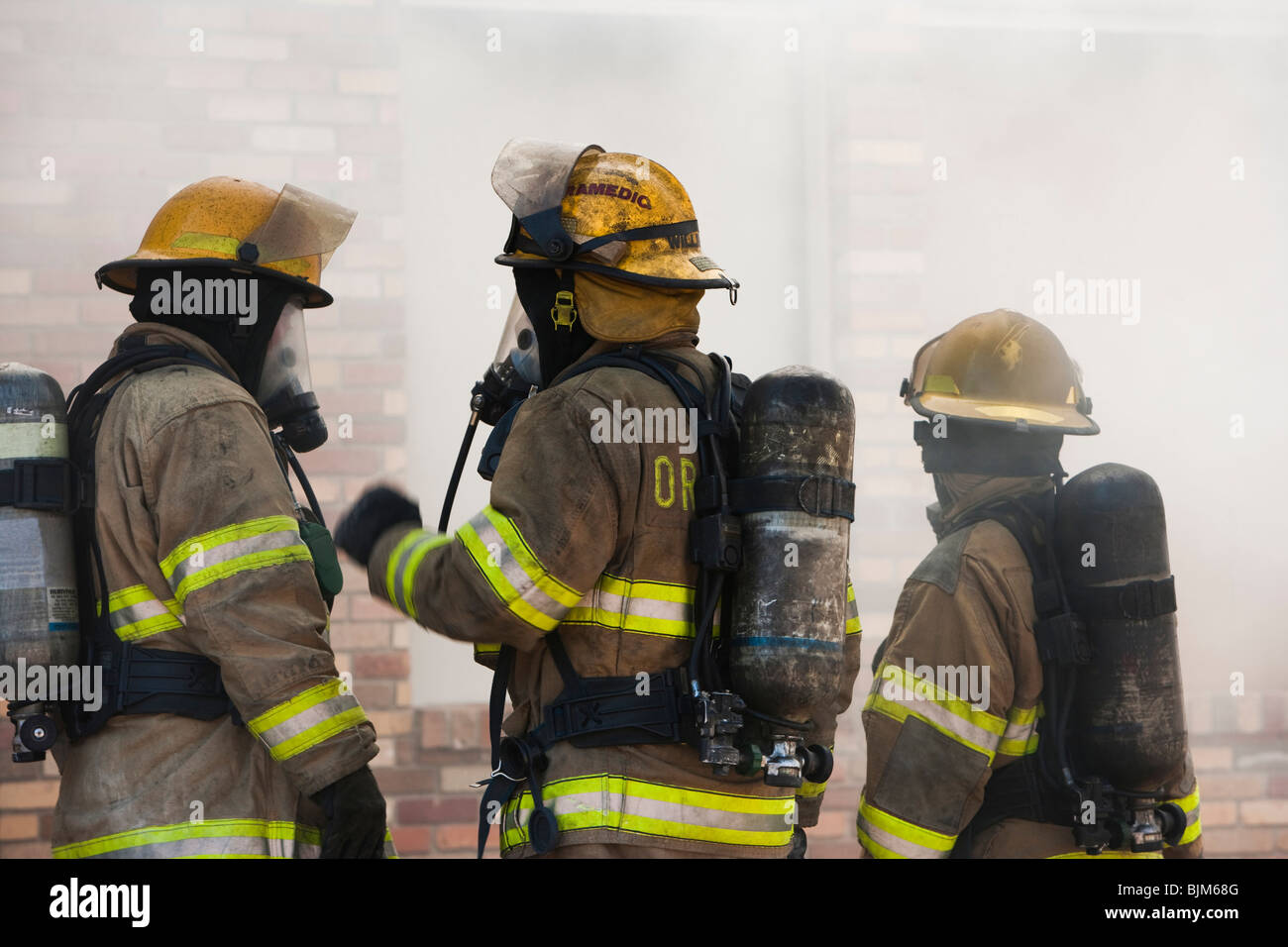 Rear View of Fire fighters Stock Photo - Alamy