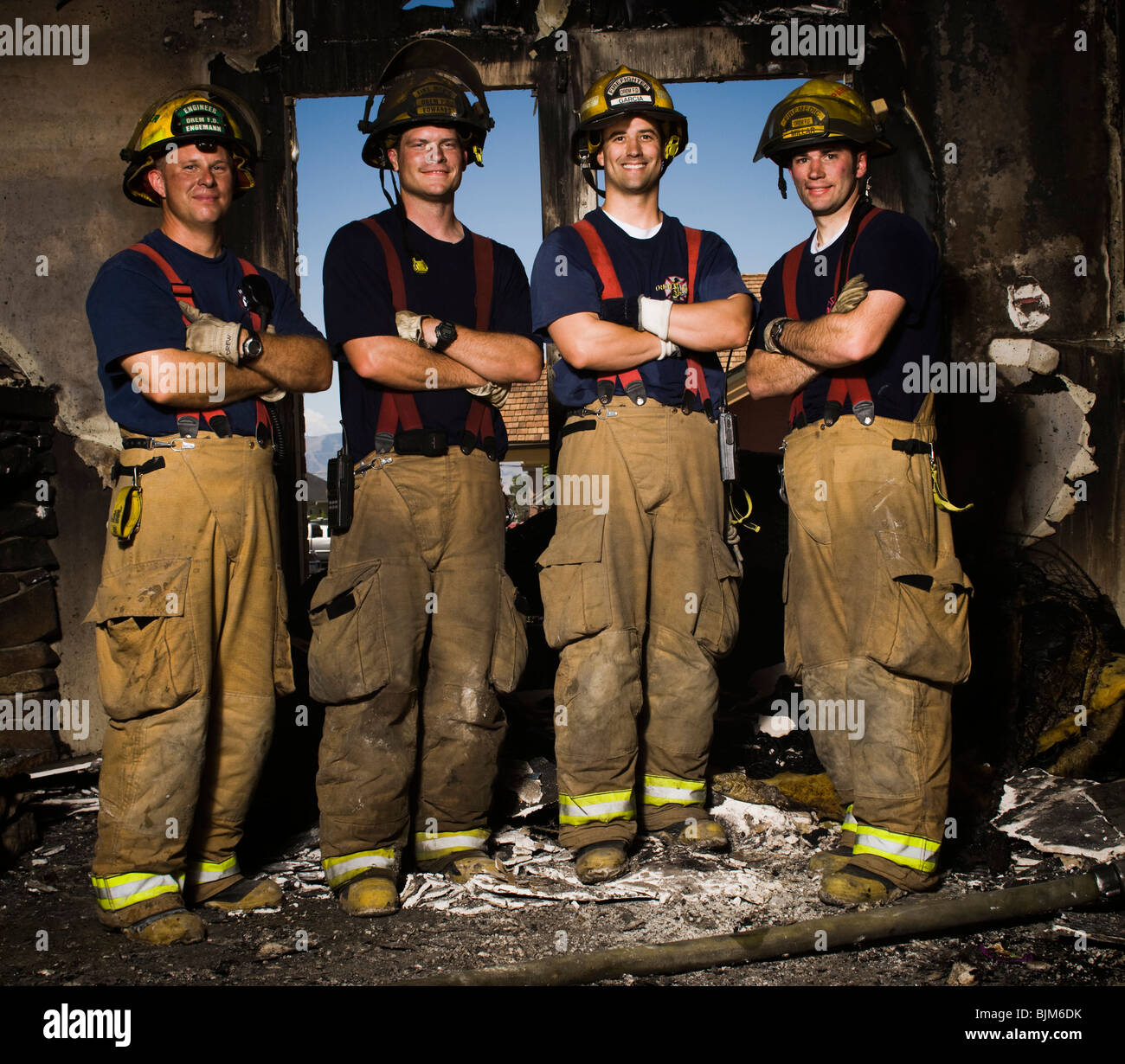 Group portrait of firefighters in burnt room Stock Photo - Alamy