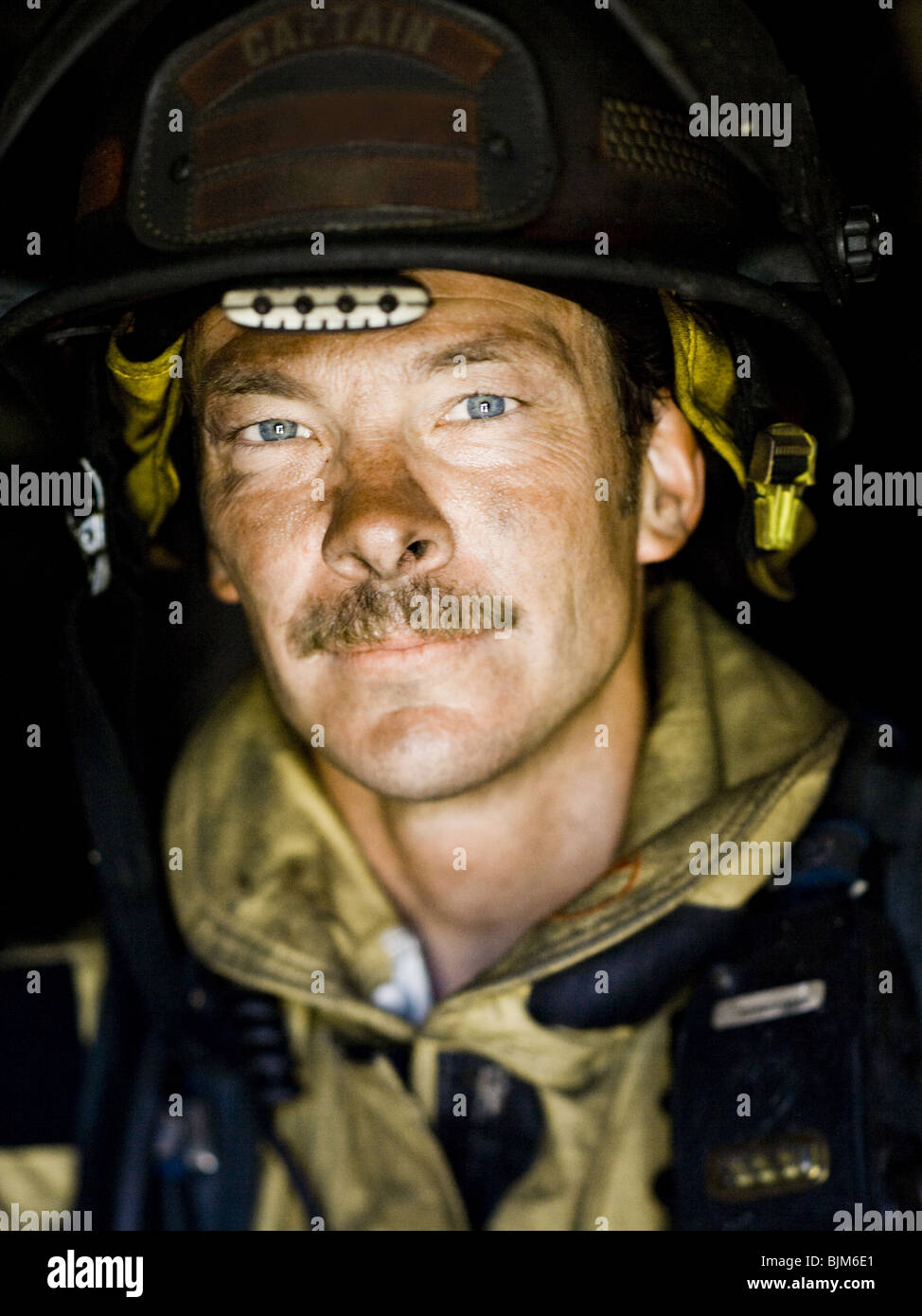 Portrait of a firefighter smiling Stock Photo - Alamy
