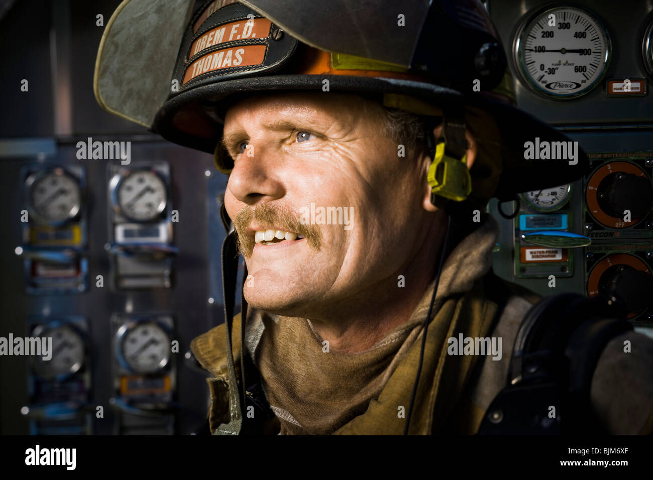 Portrait of a firefighter in front of control panel Stock Photo - Alamy