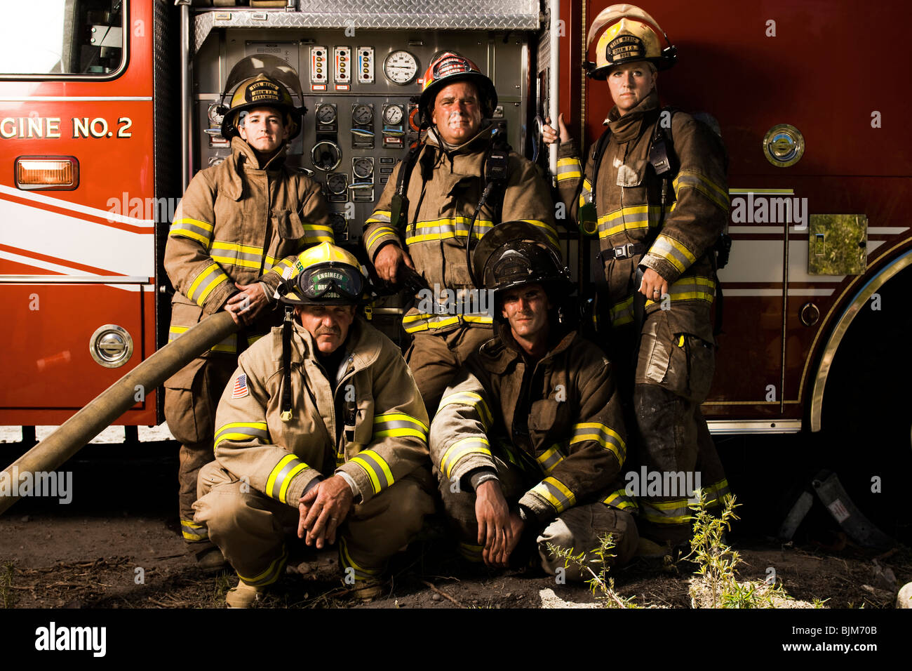 Group portrait of firefighters and fire engine Stock Photo - Alamy