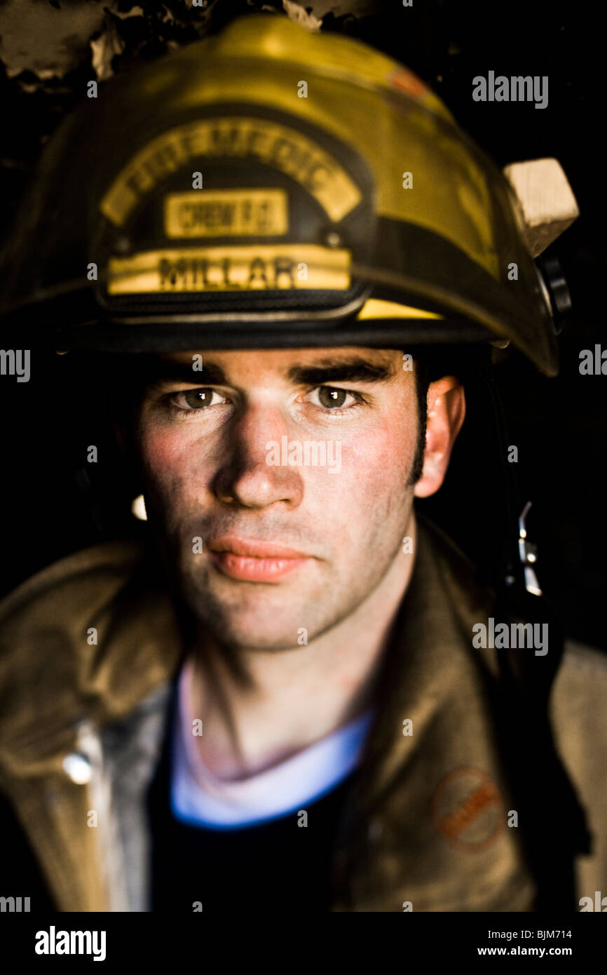 Portrait of a firefighter with fire hose Stock Photo - Alamy