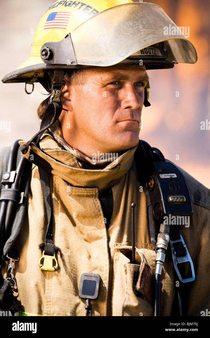 Portrait of a firefighter with fire in background Stock Photo - Alamy