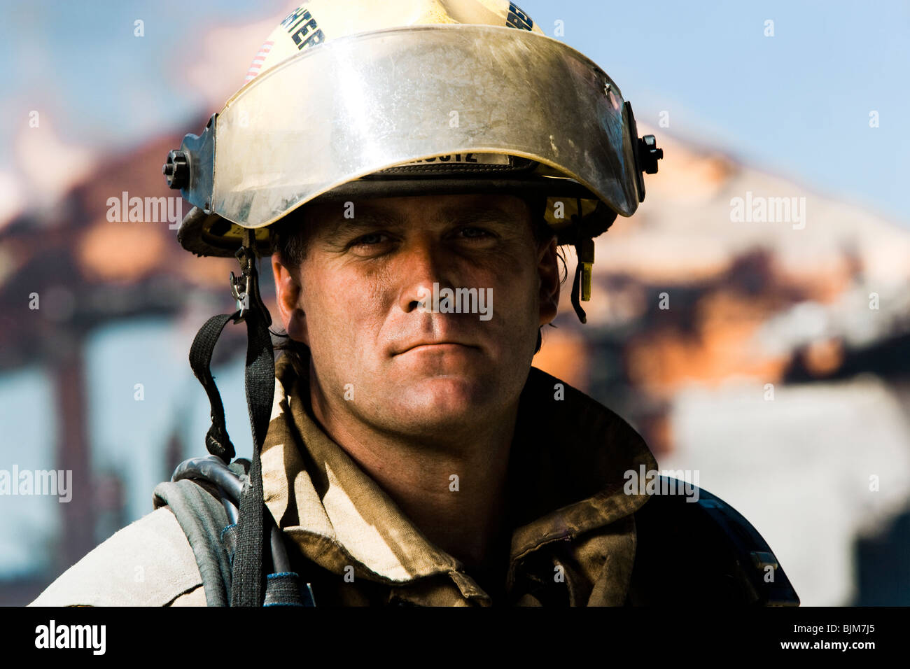 Portrait of a firefighter with fire in background Stock Photo - Alamy