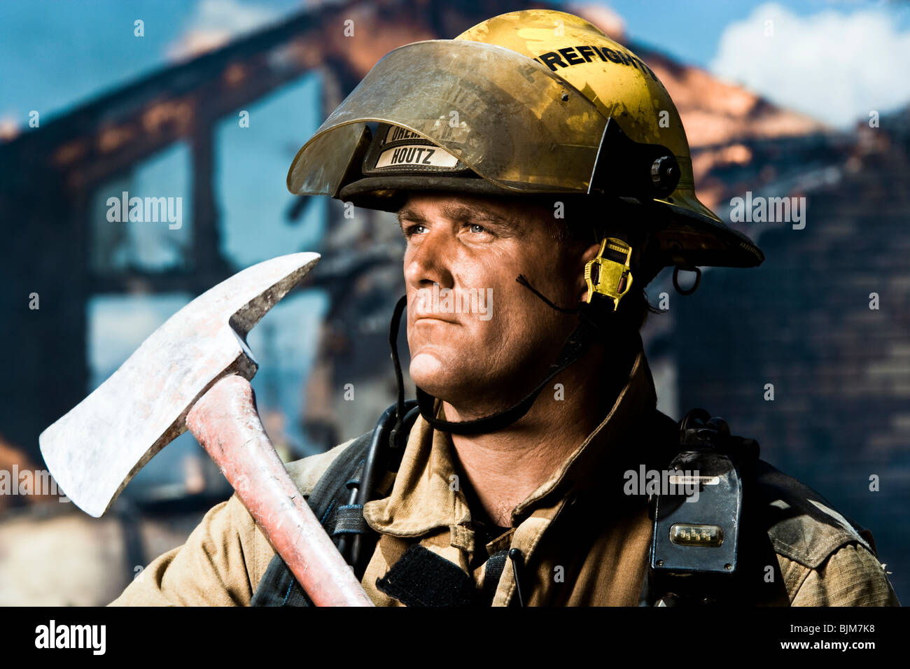 Portrait of a firefighter with axe Stock Photo - Alamy