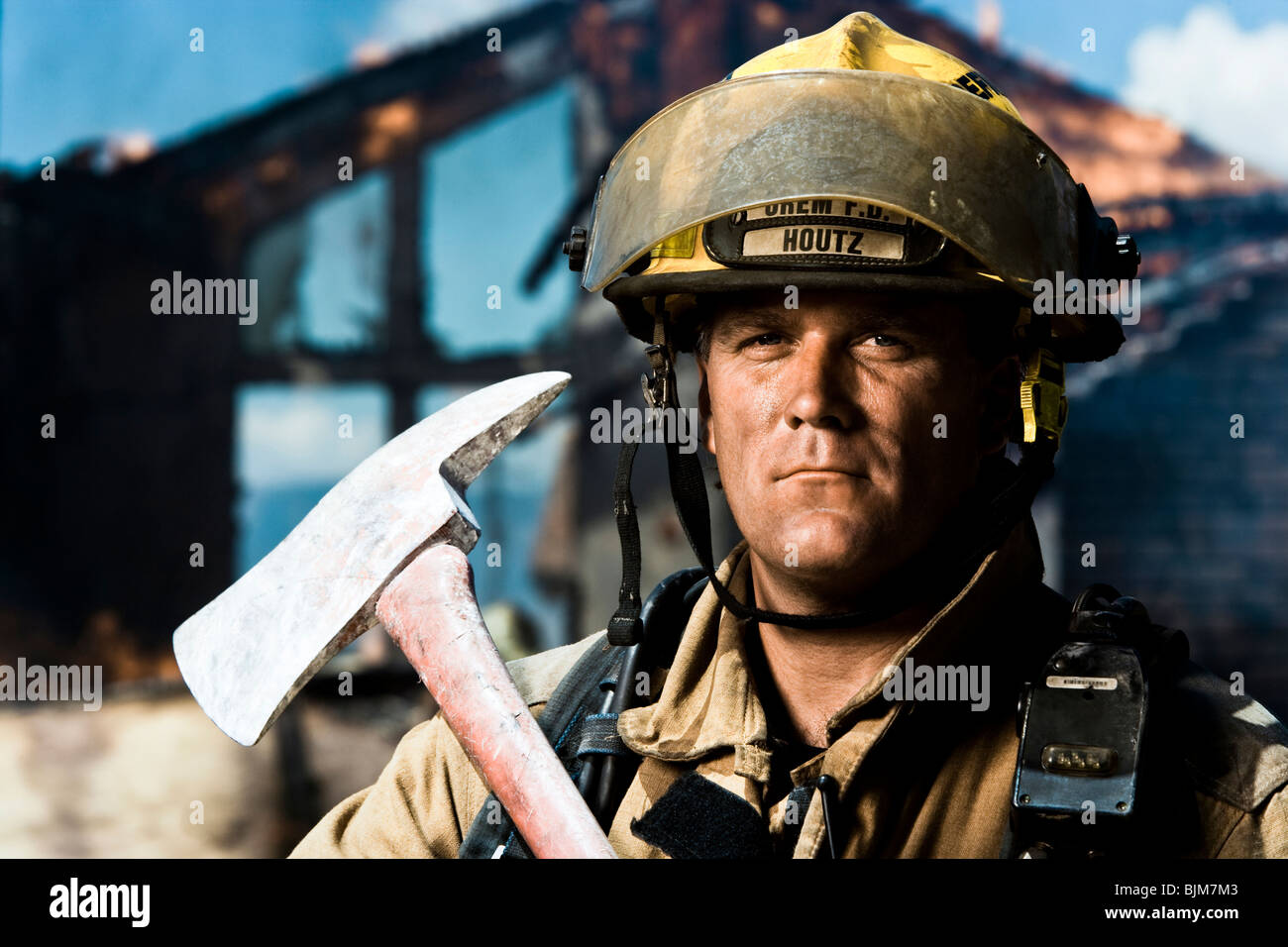 Portrait of a firefighter with axe Stock Photo - Alamy