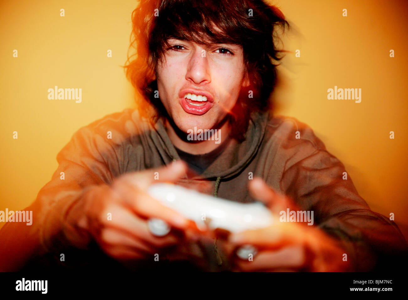 Young man holding a game console in his hand and complaining about a ...