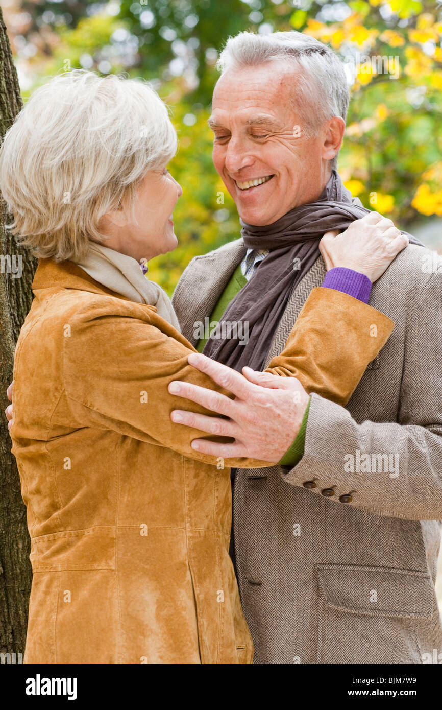 Mature couple embracing outdoors Stock Photo - Alamy